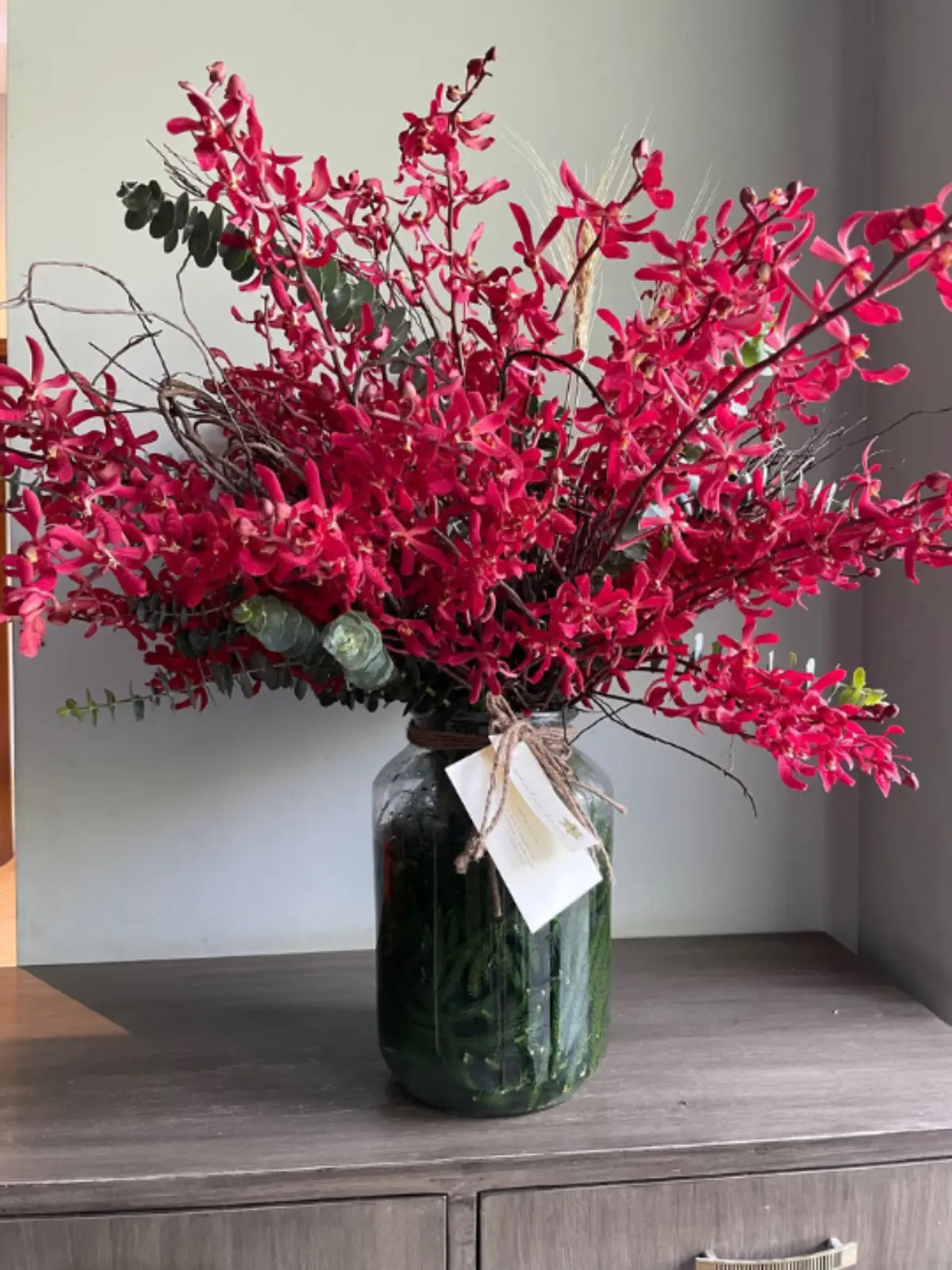 Red Aranthera Orchid & Eucalyptus Floral Arrangement